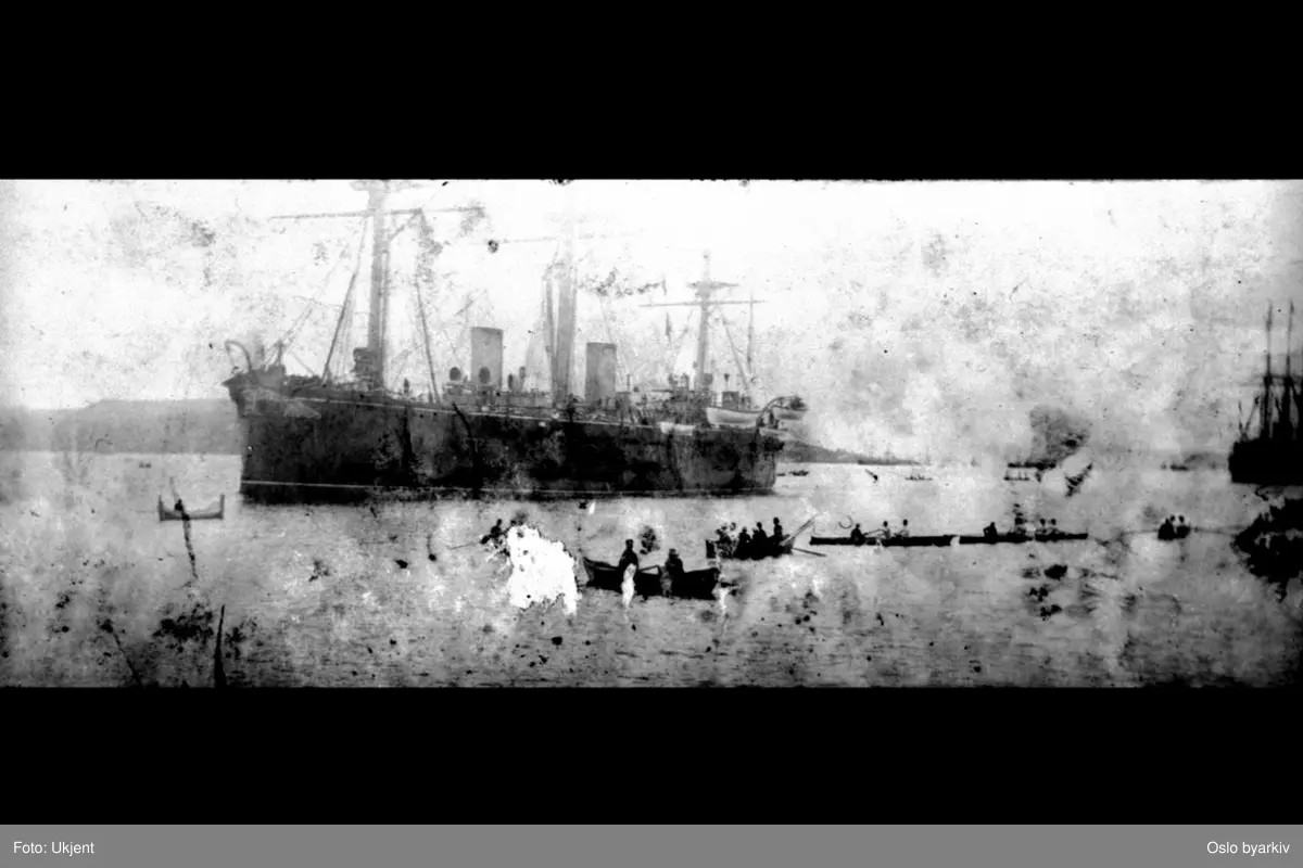 Dampskip på fjorden med småbåter omkring. Sannsynligvis fra den tyske ...